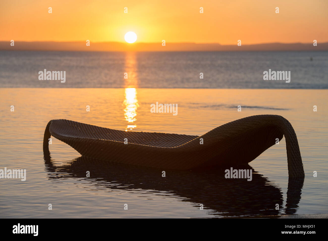 floating sun chair by the sea at sunset Stock Photo - Alamy