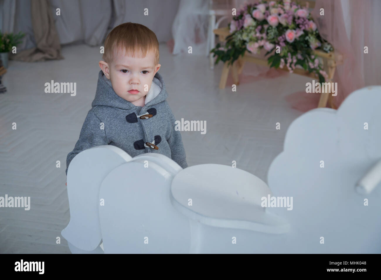 Little boy playing near wooden rocking horse Stock Photo - Alamy