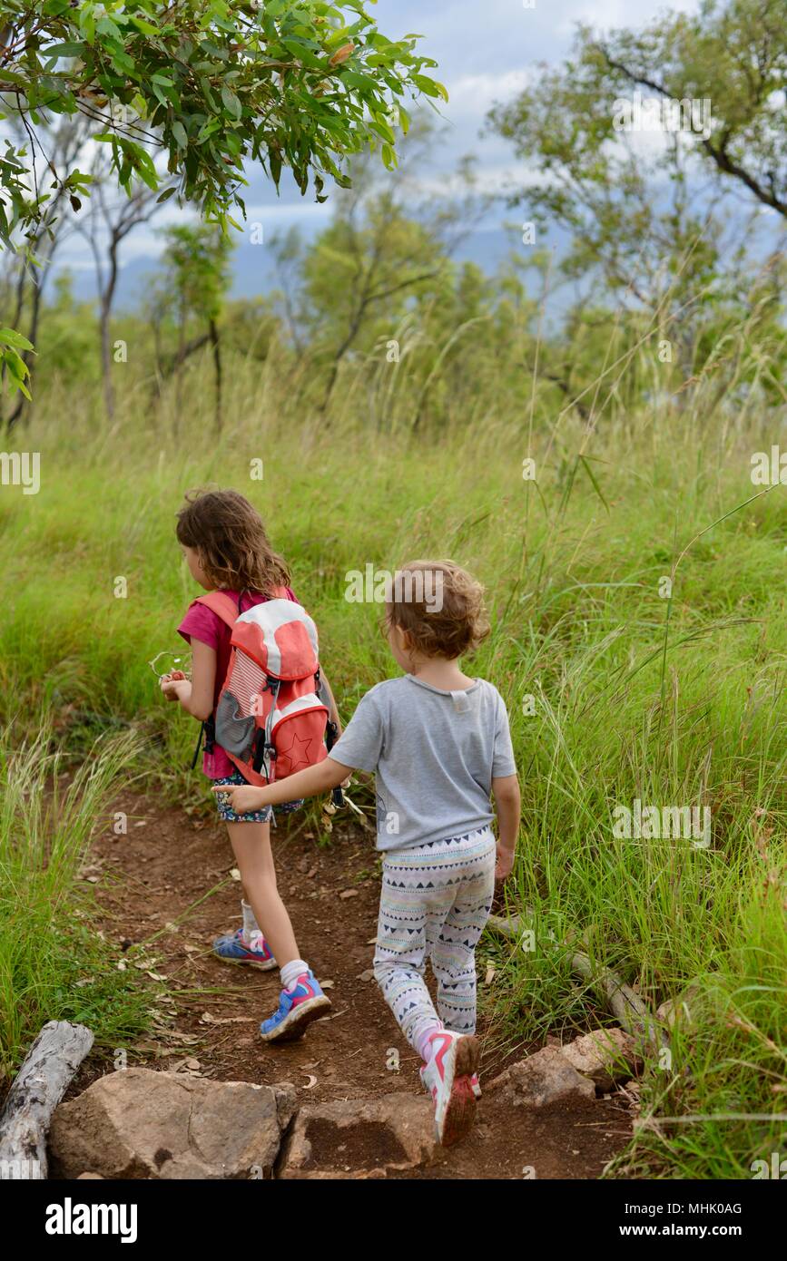 Two children walk along a path through a forest, Mount Stuart hiking ...