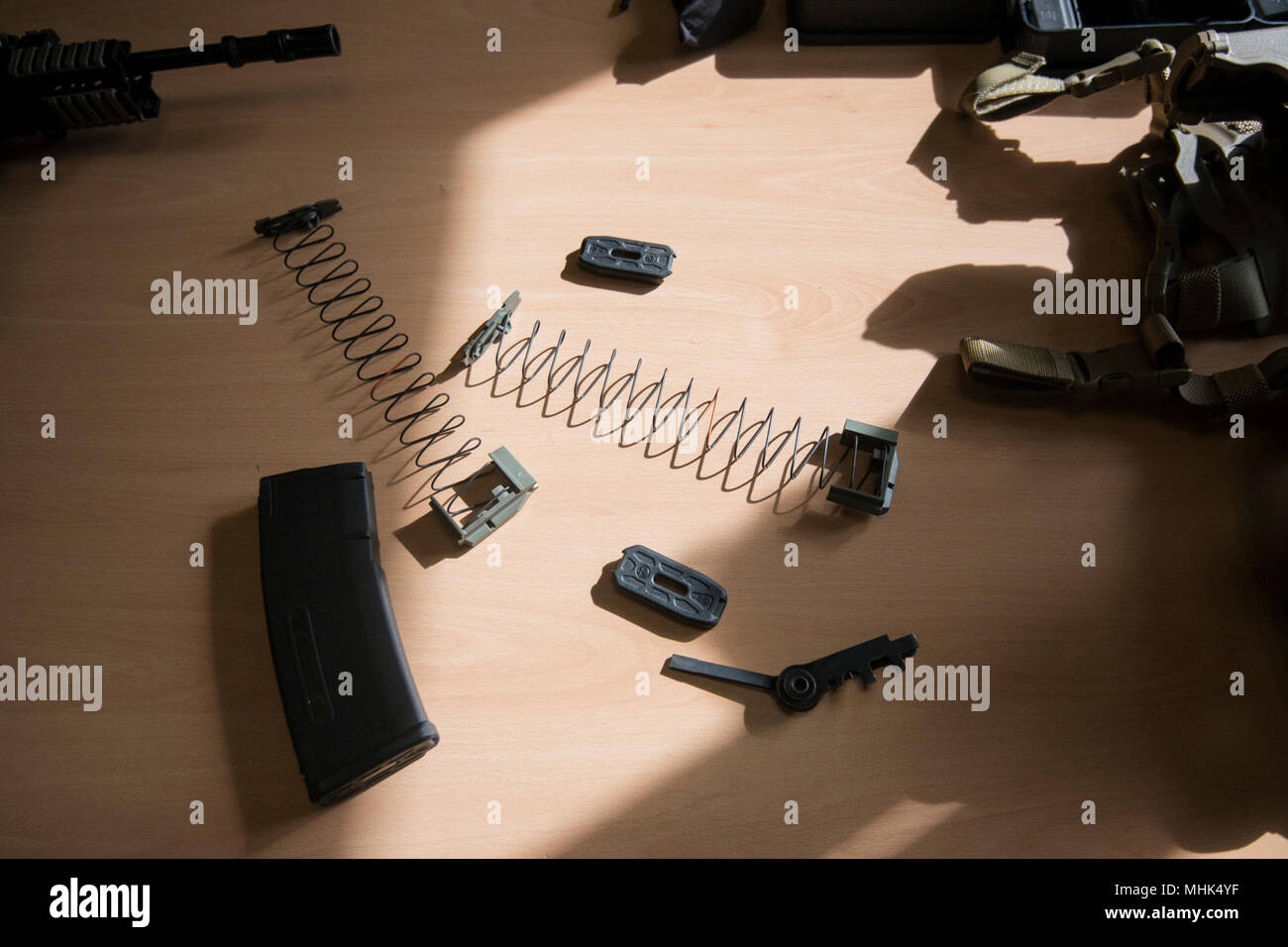 The components of a SA80A2 rifle magazine lay on a table, as members of ...
