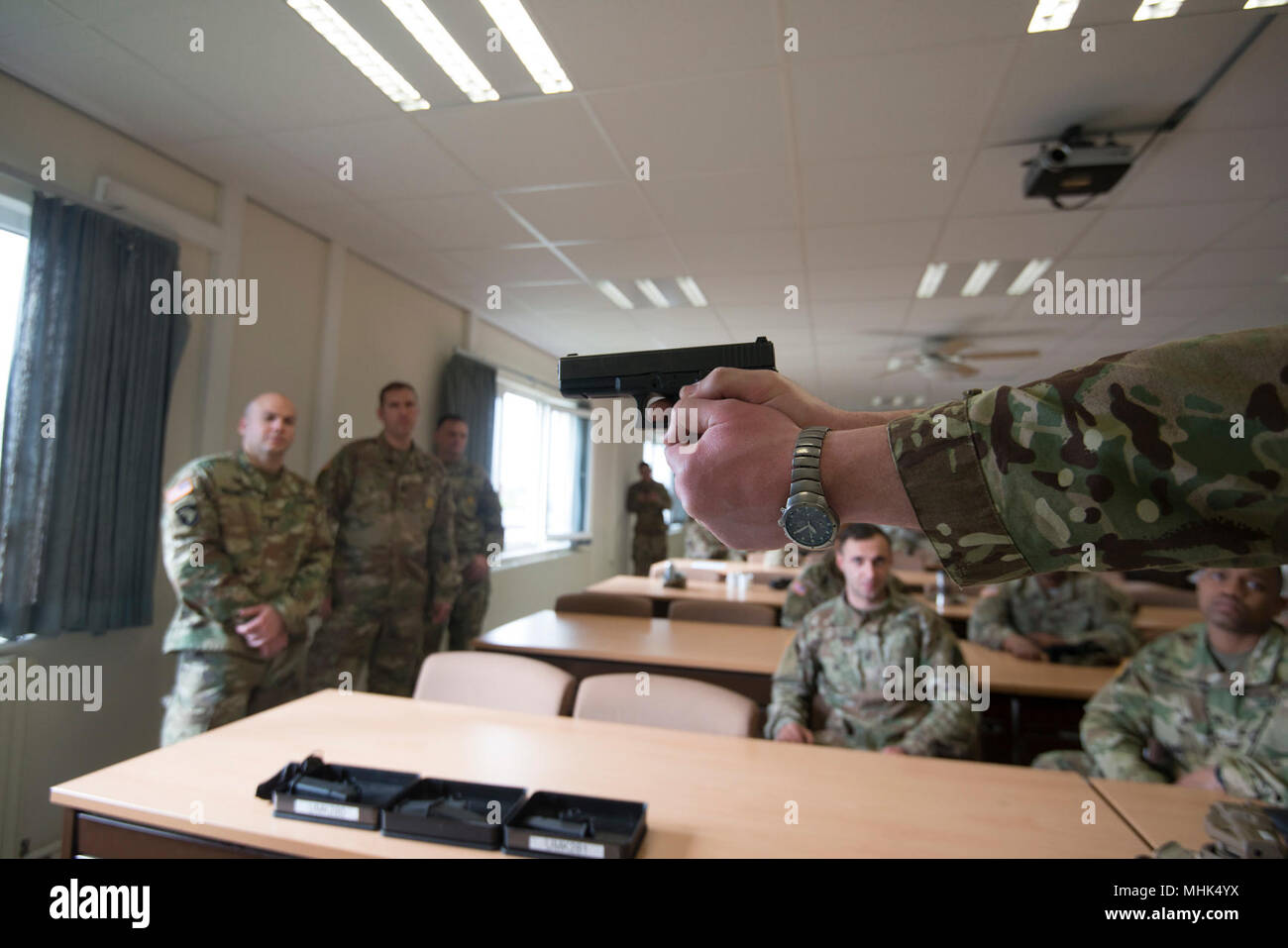 U.S. Soldiers watch a Glock 17 presentation made by a member of the ...