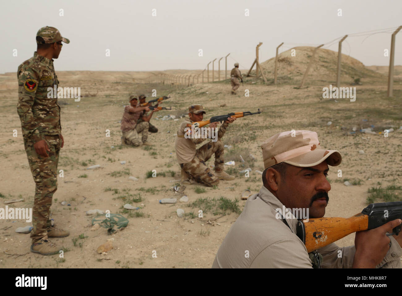 Iraqi members with the Desert Battalion practice getting on line and ...