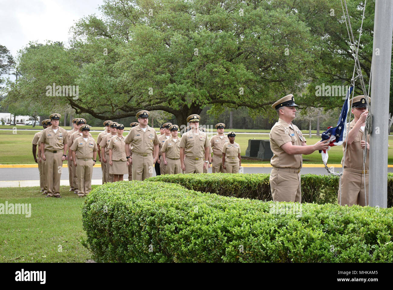 AGC Jason Archibald (left) and AGC Chad Collier (right) raise the flag ...
