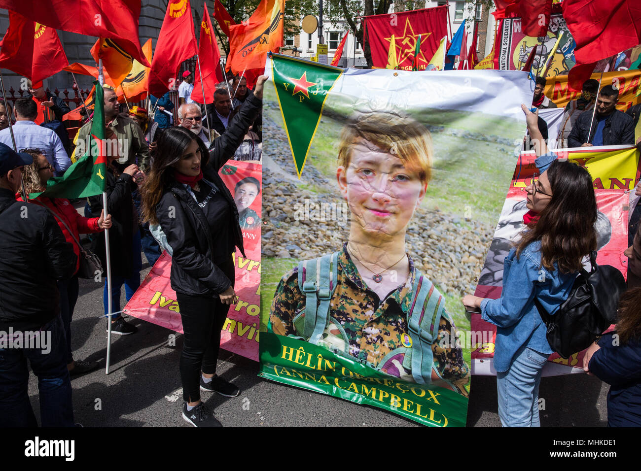London, UK. 1st May, 2018. Kurdish YPG supporters carry an image of ...