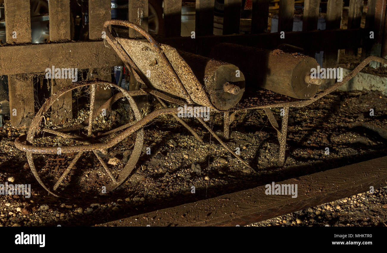 old wheelbarrow in barn with wood Stock Photo - Alamy