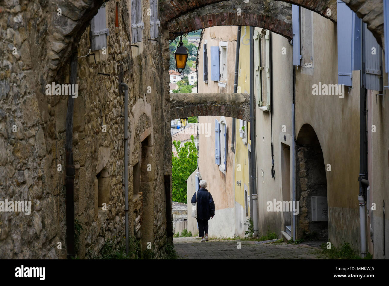 Woman walking in a village street, Livron-sur-Drome, Drôme, France ...
