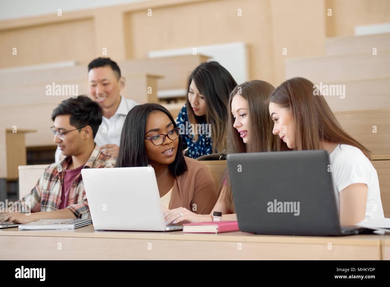 Concentrated girls coworking foe scientific project. Girls wearing ...