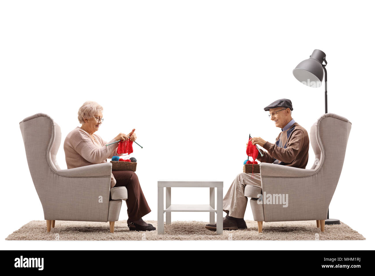Seniors sitting in armchairs and knitting isolated on white background ...