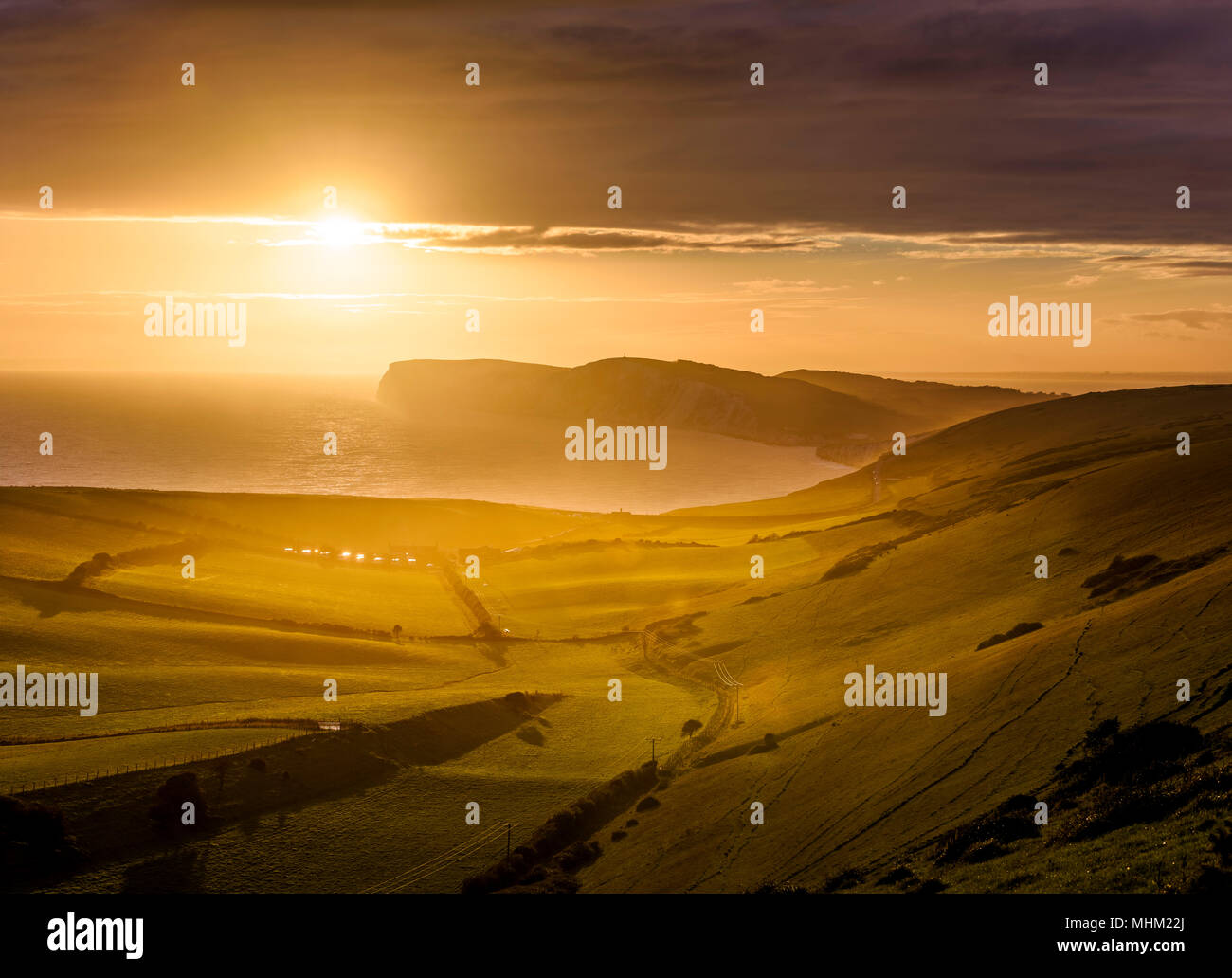 Sun below the clouds over the countryside and coast at Tennyson Down ...