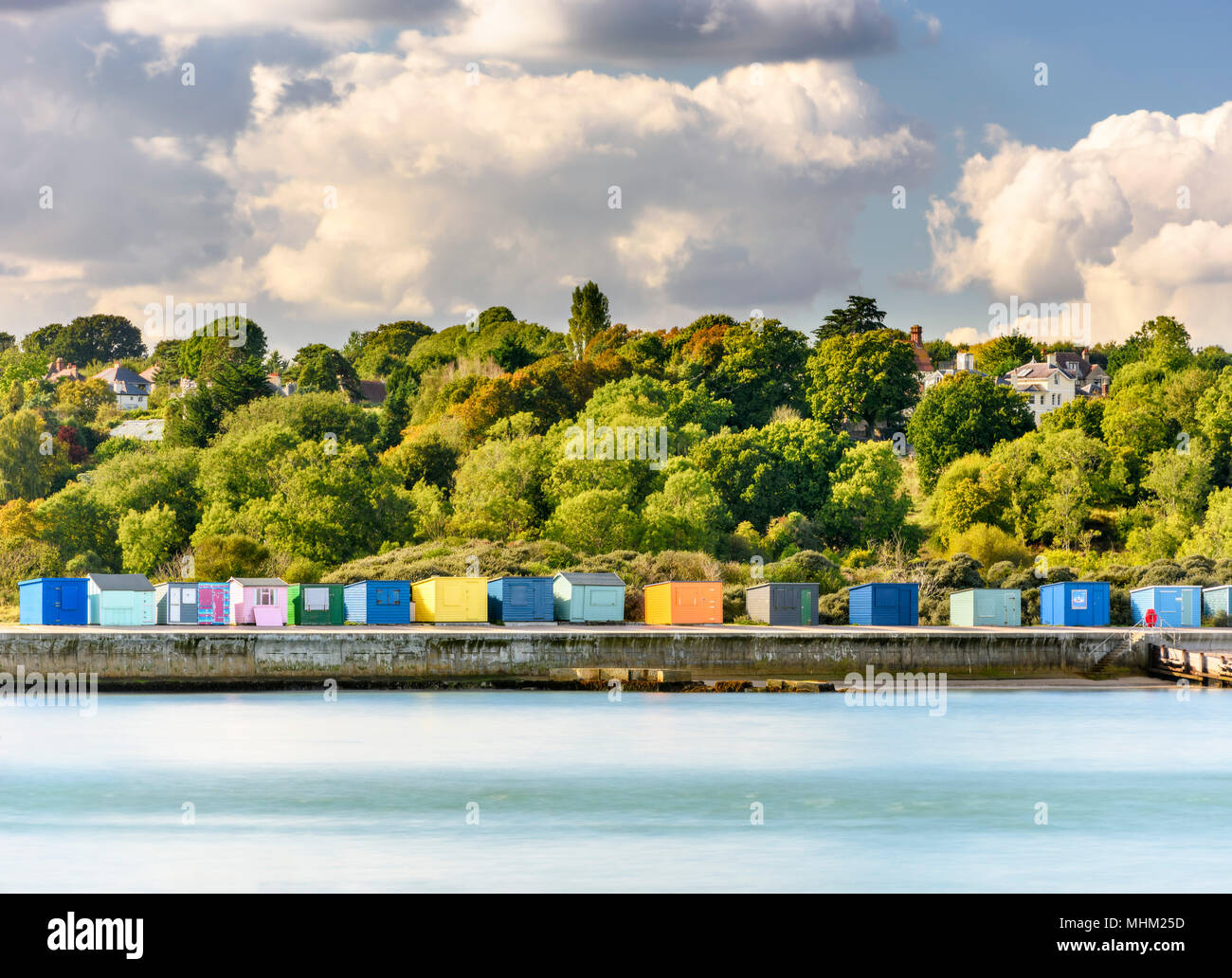 Colourful beach huts with blue sea and trees at the Duver Stock Photo ...