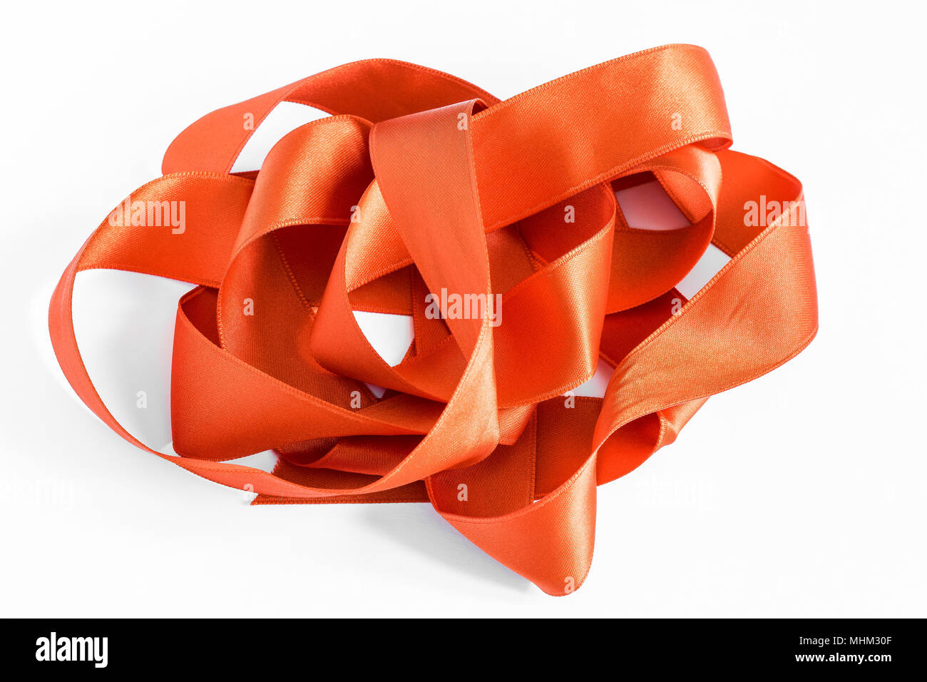 A tangled red ribbon on a white background Stock Photo - Alamy