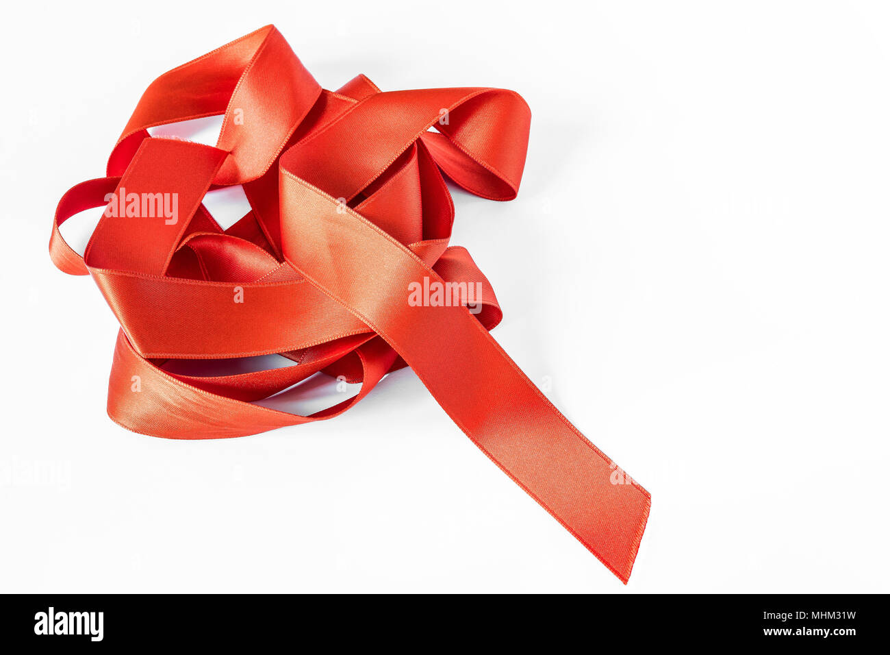 A tangled red ribbon on a white background Stock Photo - Alamy