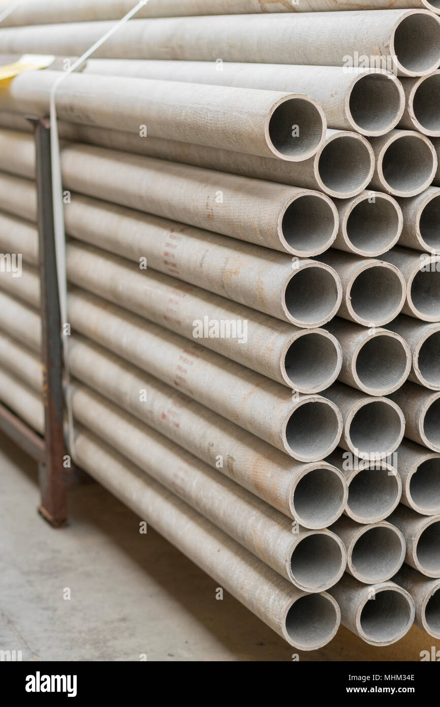 asbestos pipes in a stack in a warehouse or in a building store ...