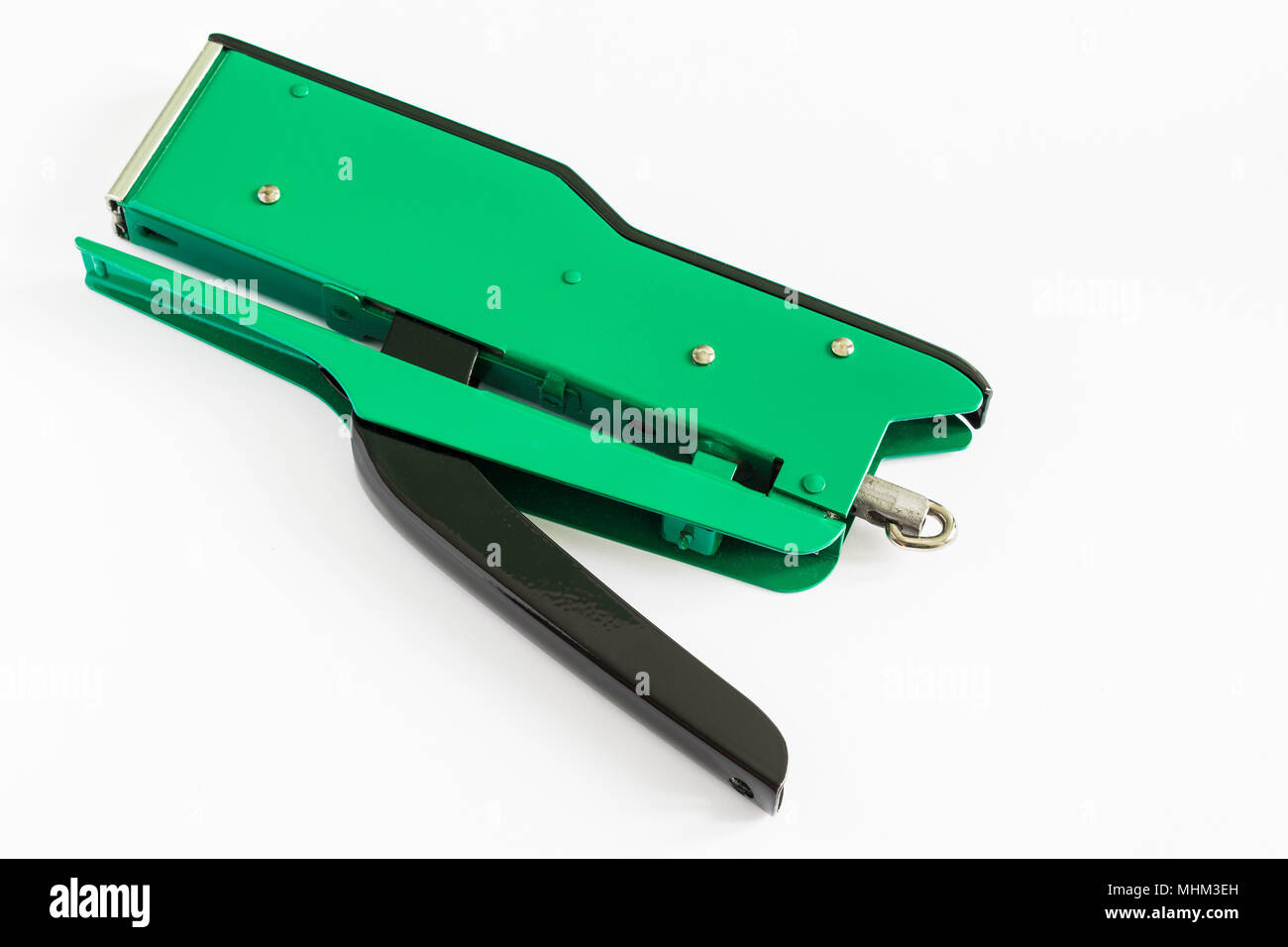 A green stapler on a white background Stock Photo - Alamy