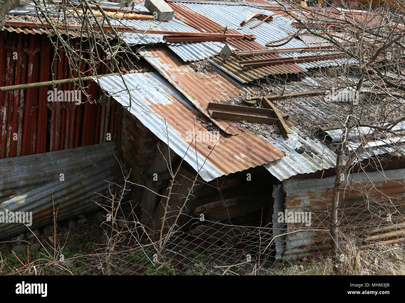 broken house with unsafe roof made of sheet metal Stock Photo - Alamy