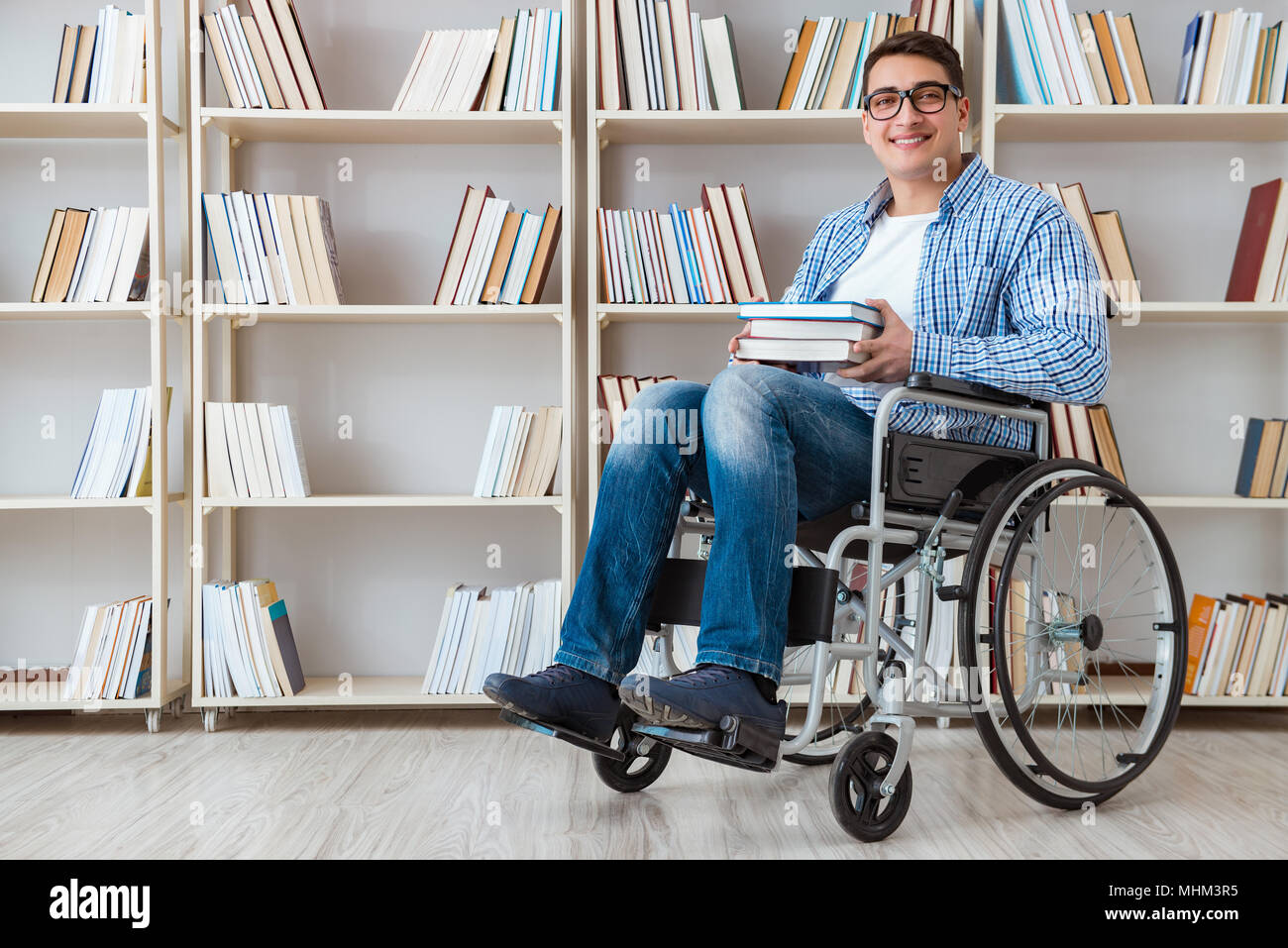 Disabled student studying in the library Stock Photo - Alamy
