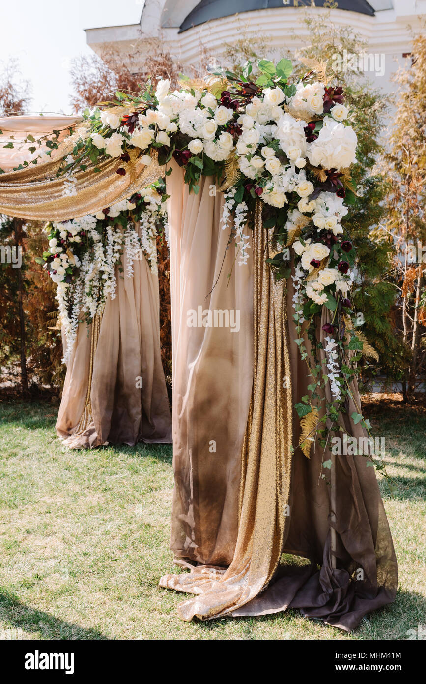 Wedding arch decorated with flowers and fabric hi-res stock photography ...