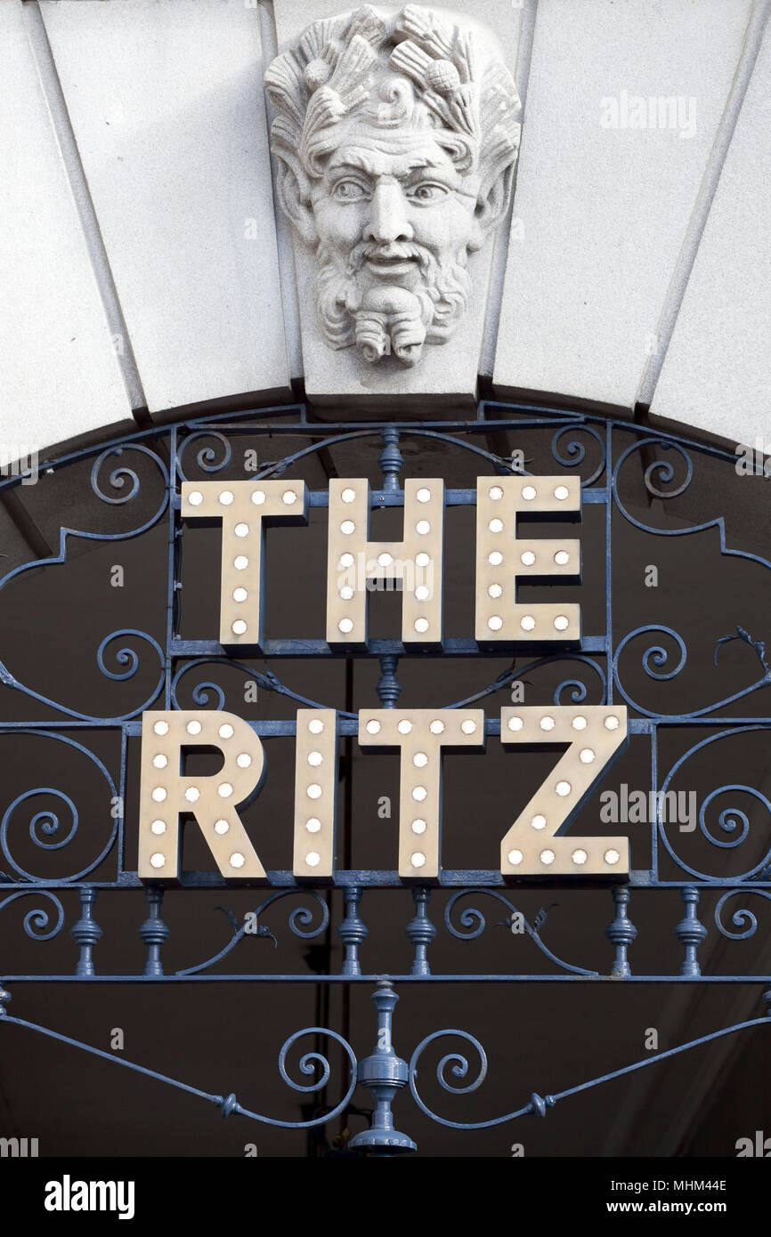 The Ritz London hotel sign above walkway with stone engraved mans head ...