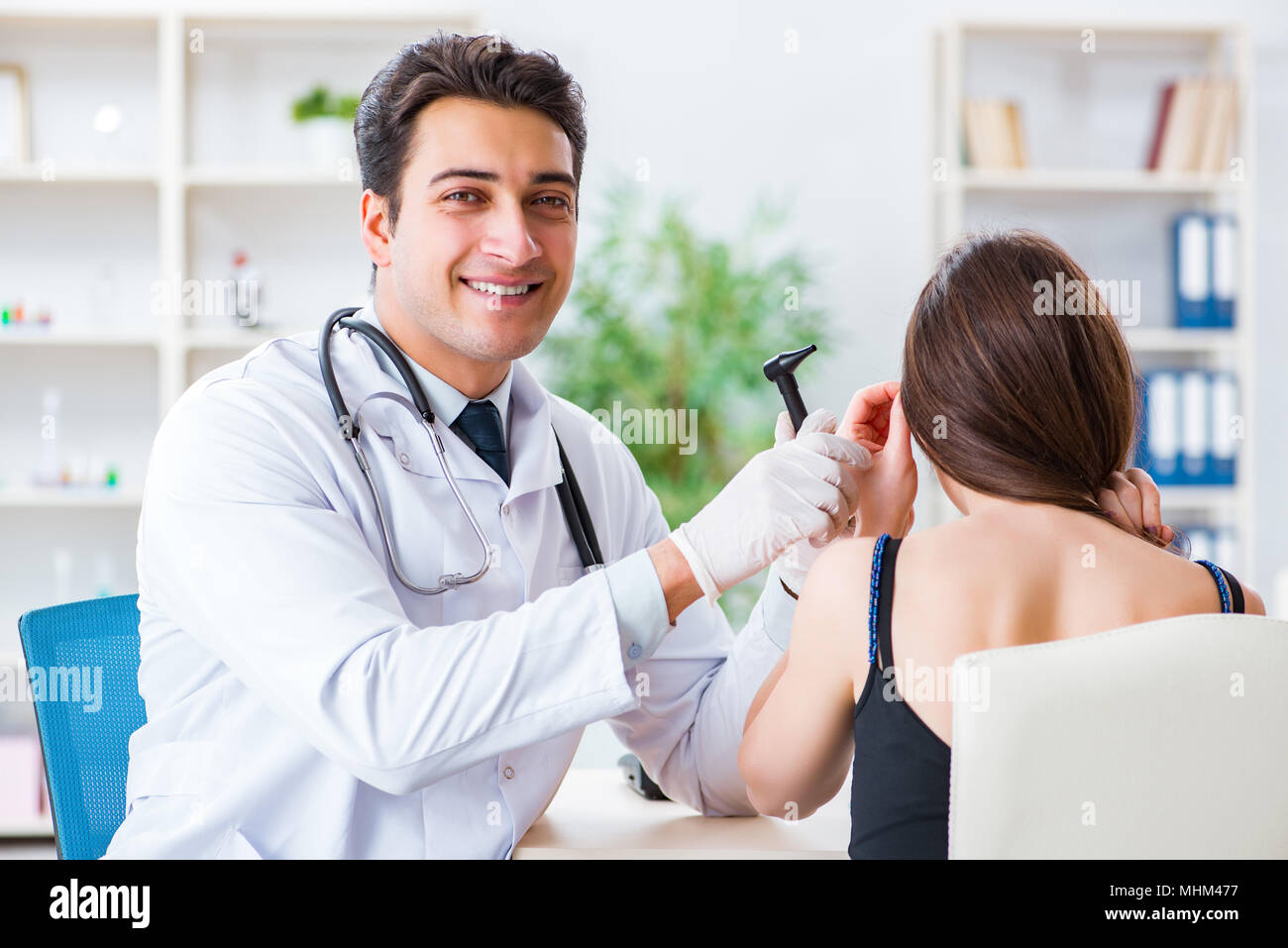 Doctor checking patients ear during medical examination Stock Photo - Alamy