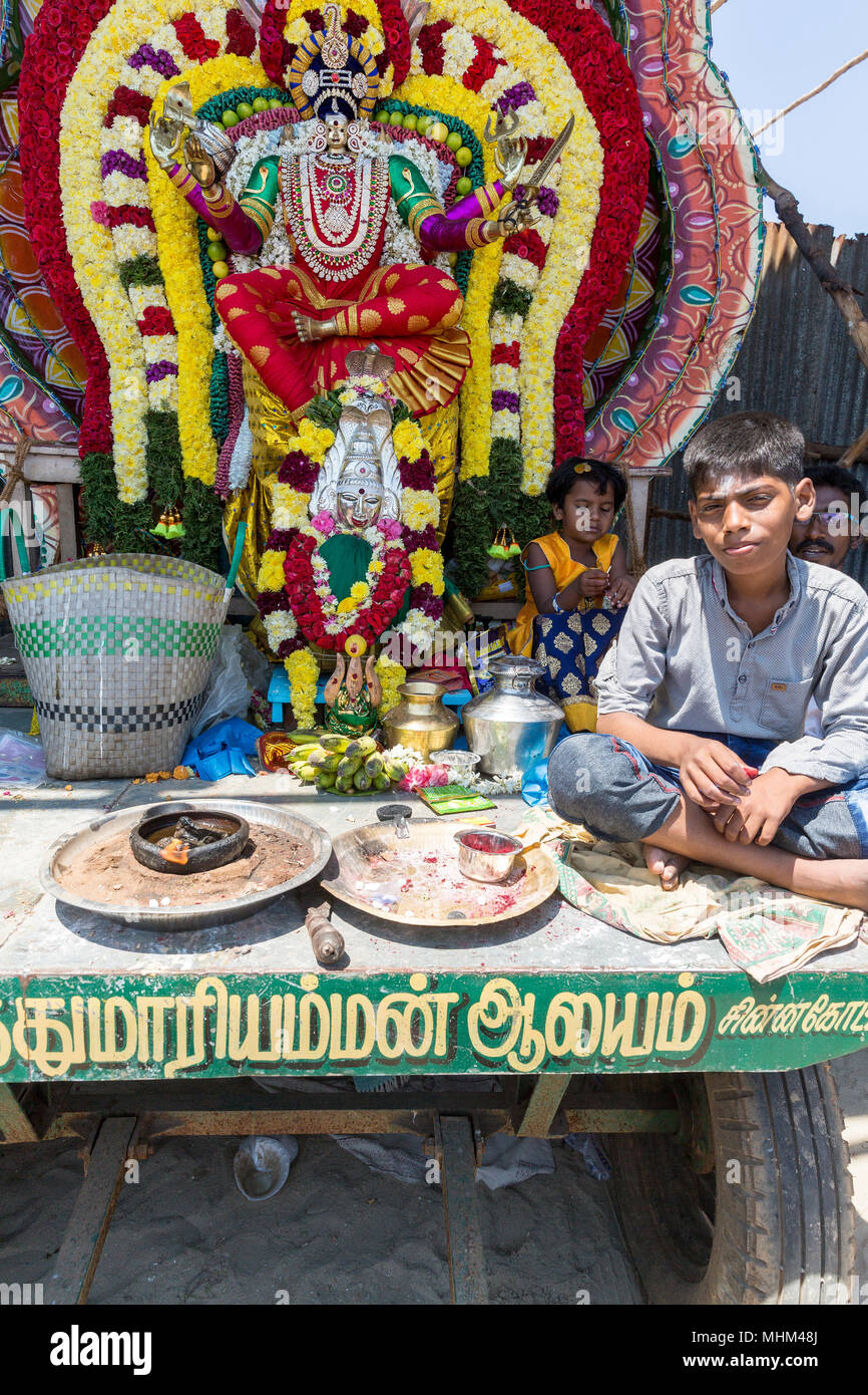 Unidentified brahman man with statues of the Indian gods and offerings ...