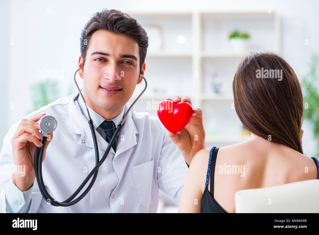 Doctor checking patient with stethoscope Stock Photo - Alamy
