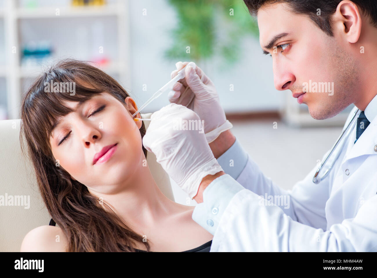 Doctor checking patients ear during medical examination Stock Photo - Alamy