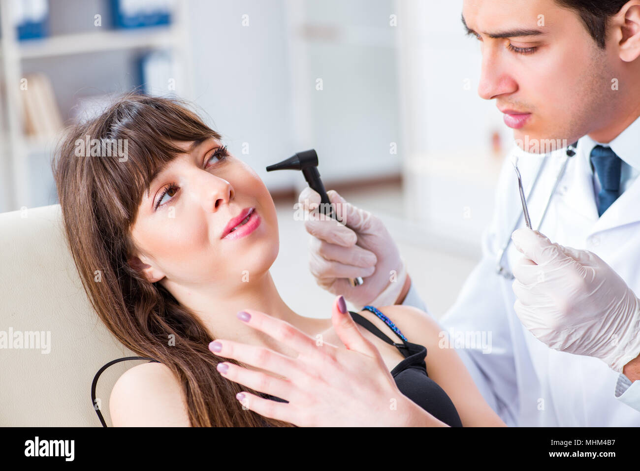 Doctor checking patients ear during medical examination Stock Photo - Alamy