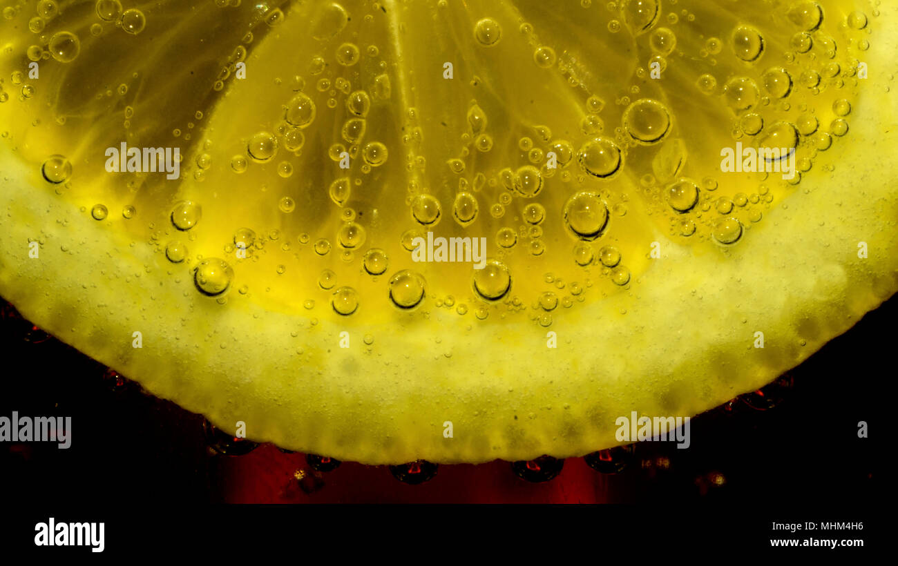 Part of lemon on soda water Stock Photo - Alamy