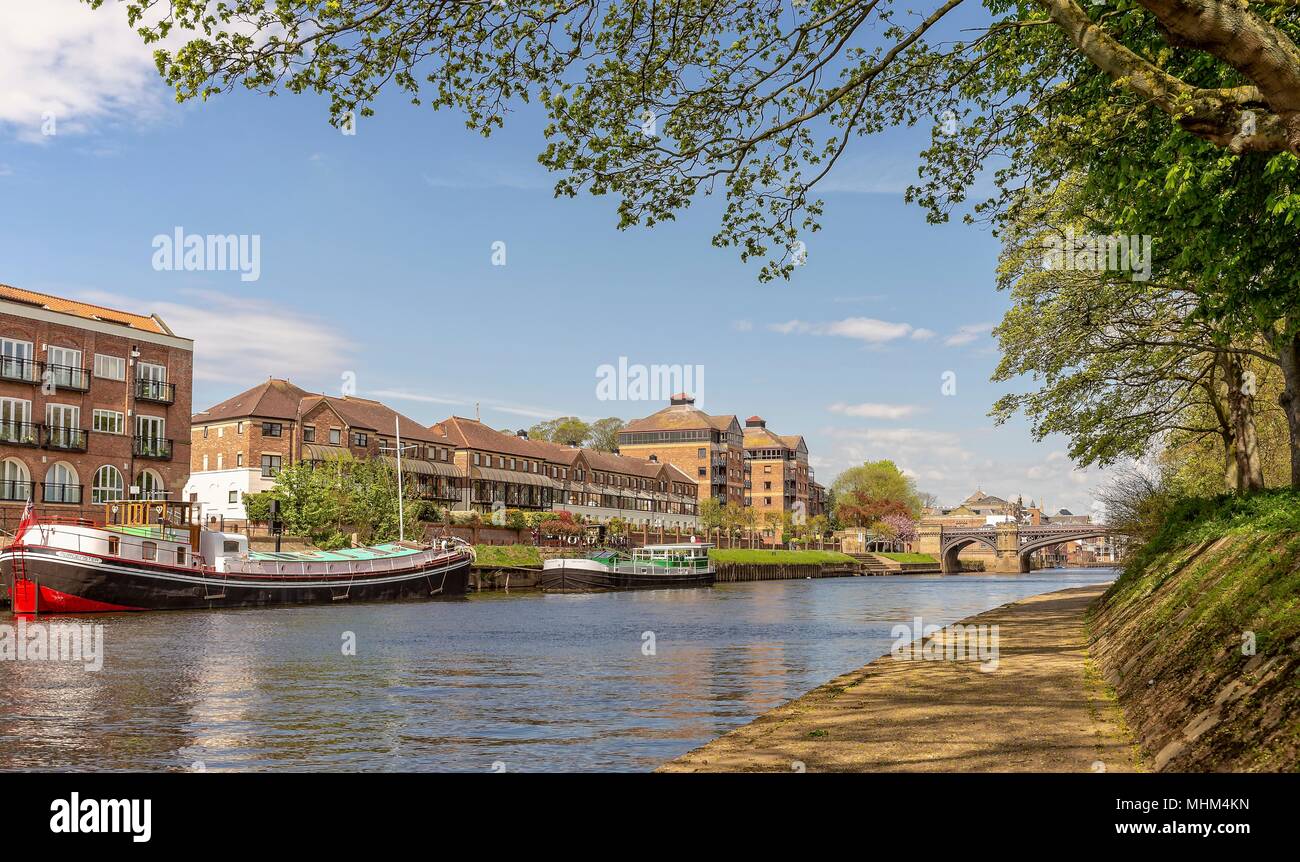 Two houseboats moored to the bank of the River Ouse in York. A ...