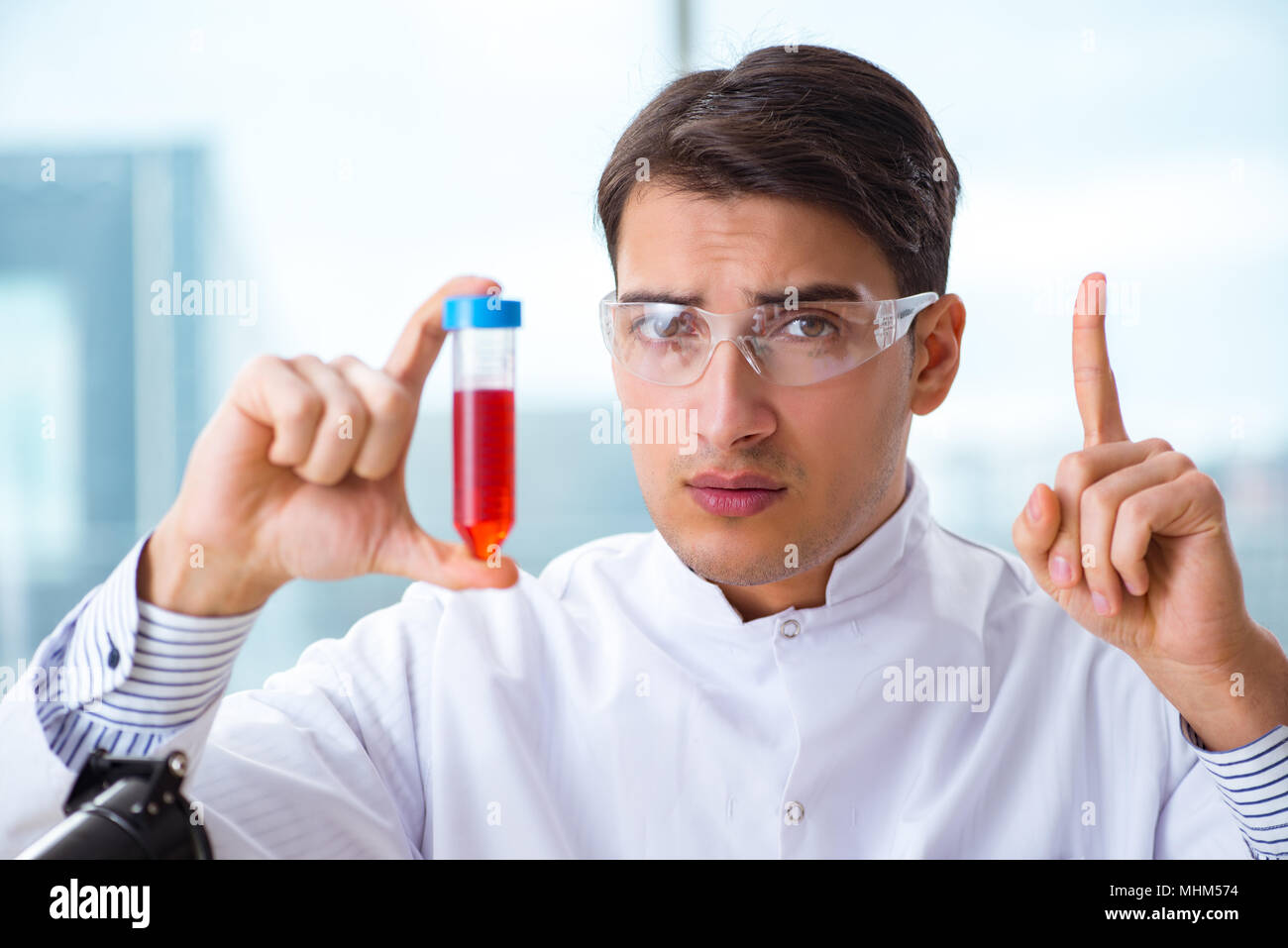 Man doctor checking blood samples in lab Stock Photo - Alamy