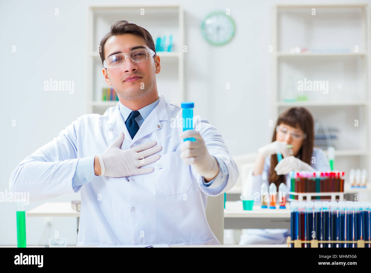 Two chemists working in lab experimenting Stock Photo - Alamy