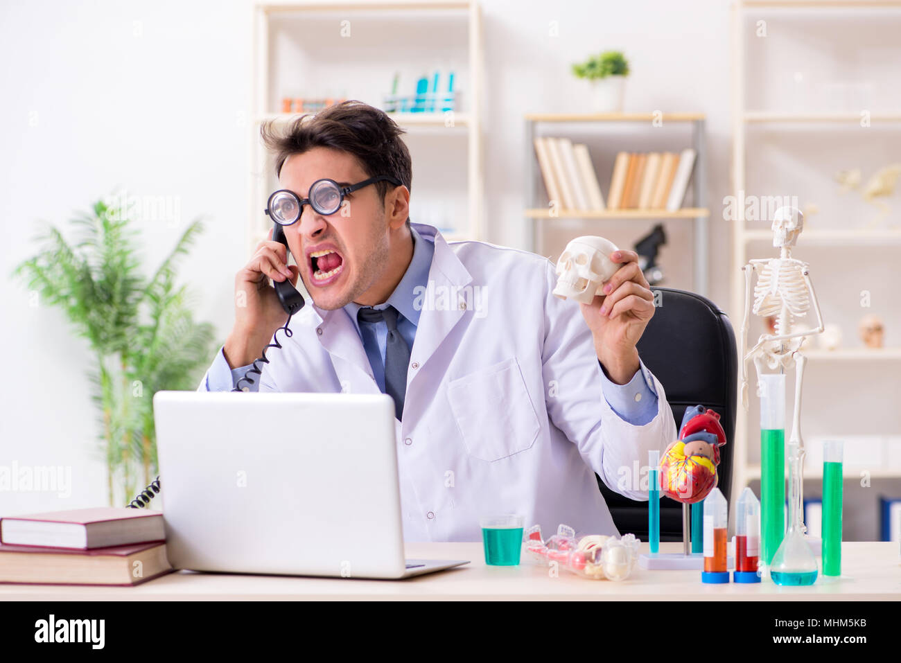 Funny doctor having fun in hospital lab Stock Photo - Alamy
