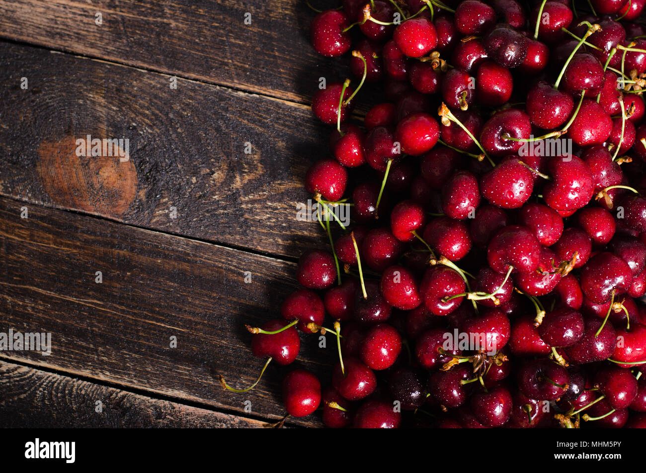 Cherry background. Fresh juicy cherries on wooden background, top view ...