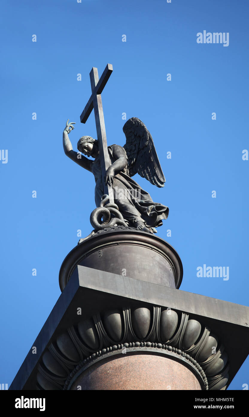 statue of winged angel with cross in blue sky Stock Photo - Alamy