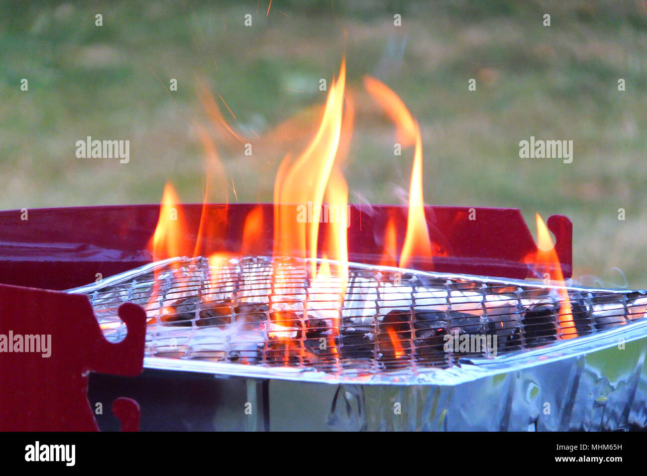 Empty Barbecue Grill with Coals and Flames Stock Photo - Alamy