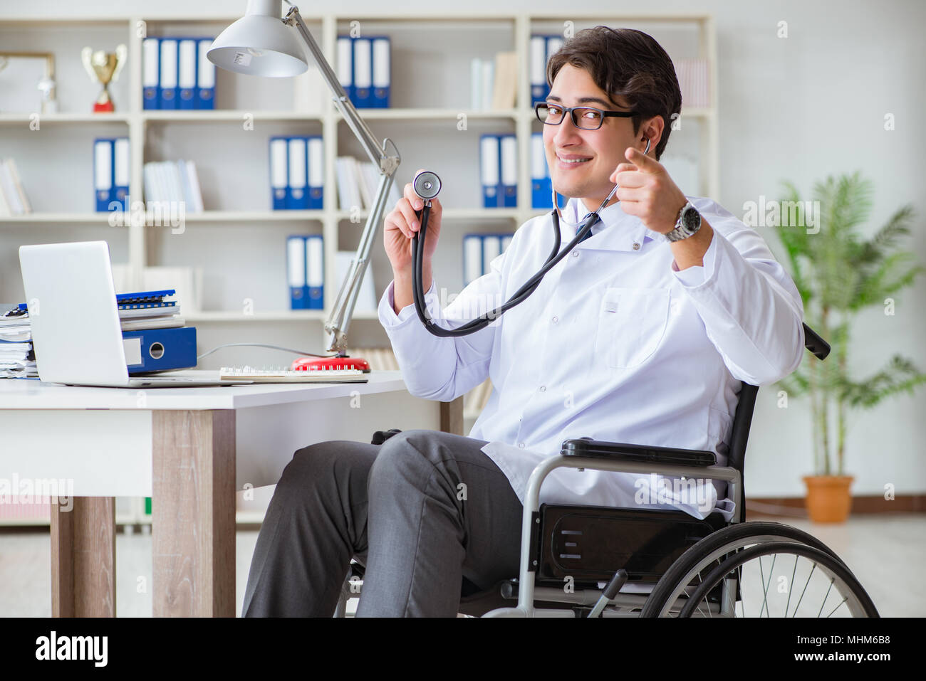Disabled doctor on wheelchair working in hospital Stock Photo - Alamy