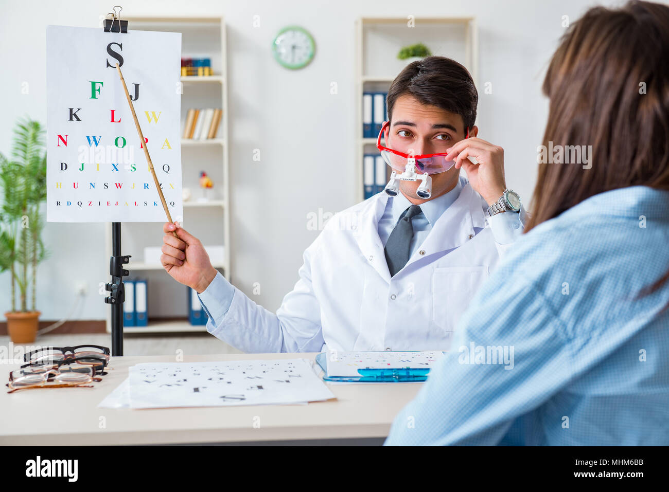 Doctor with patient at eye exam Stock Photo - Alamy