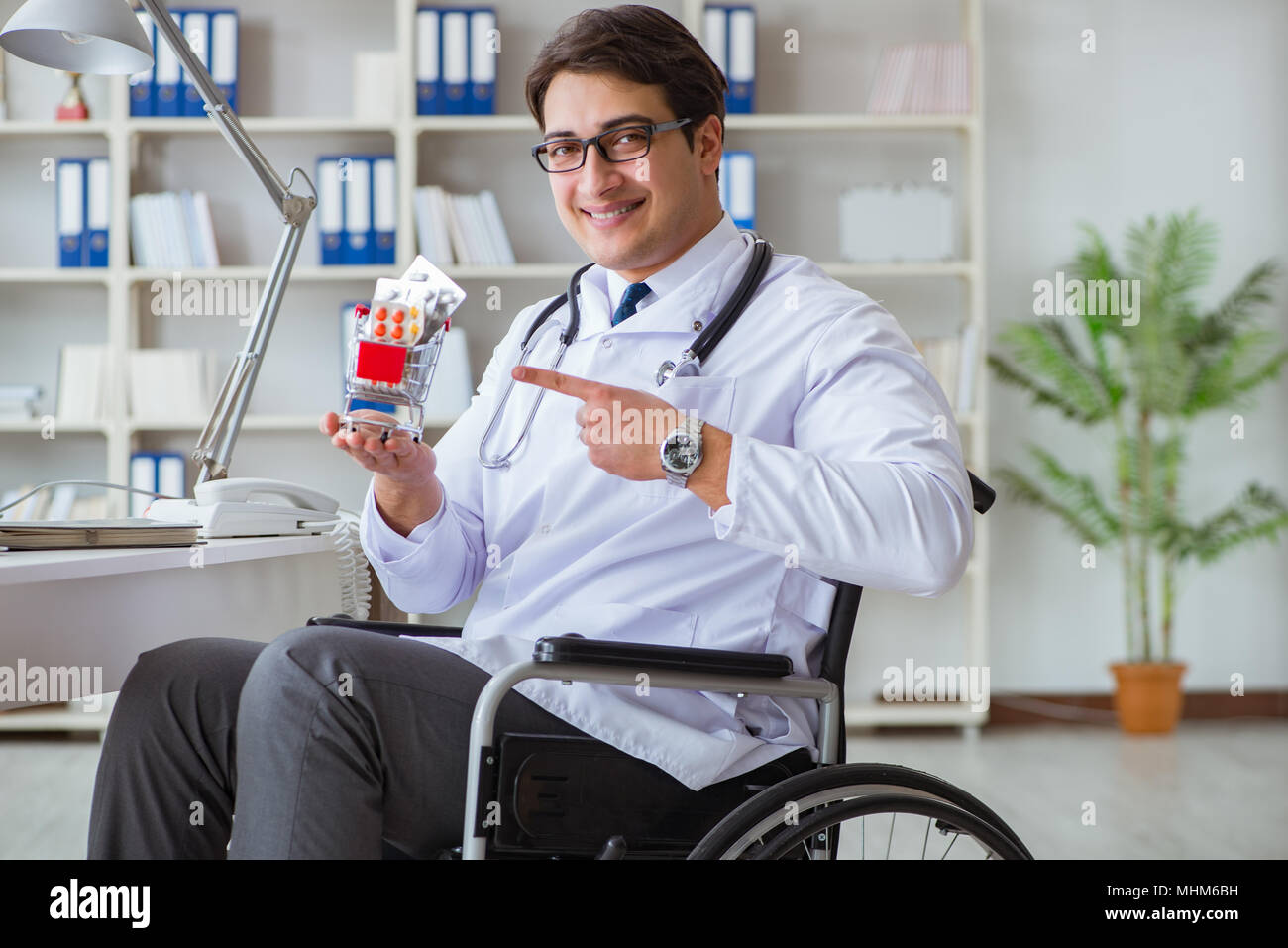 Disabled doctor on wheelchair working in hospital Stock Photo - Alamy