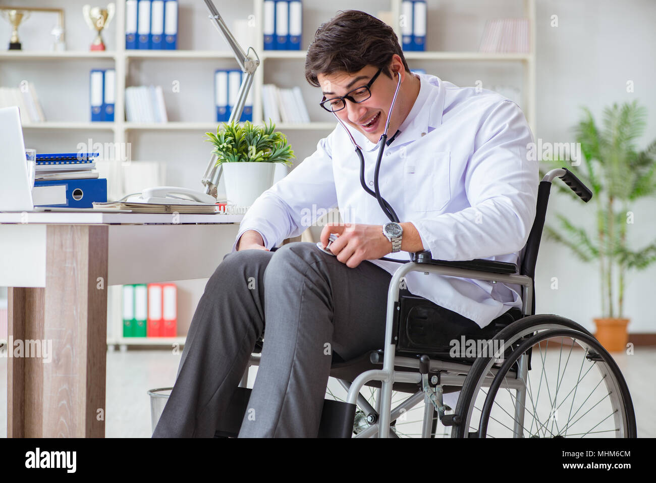 Disabled doctor on wheelchair working in hospital Stock Photo - Alamy