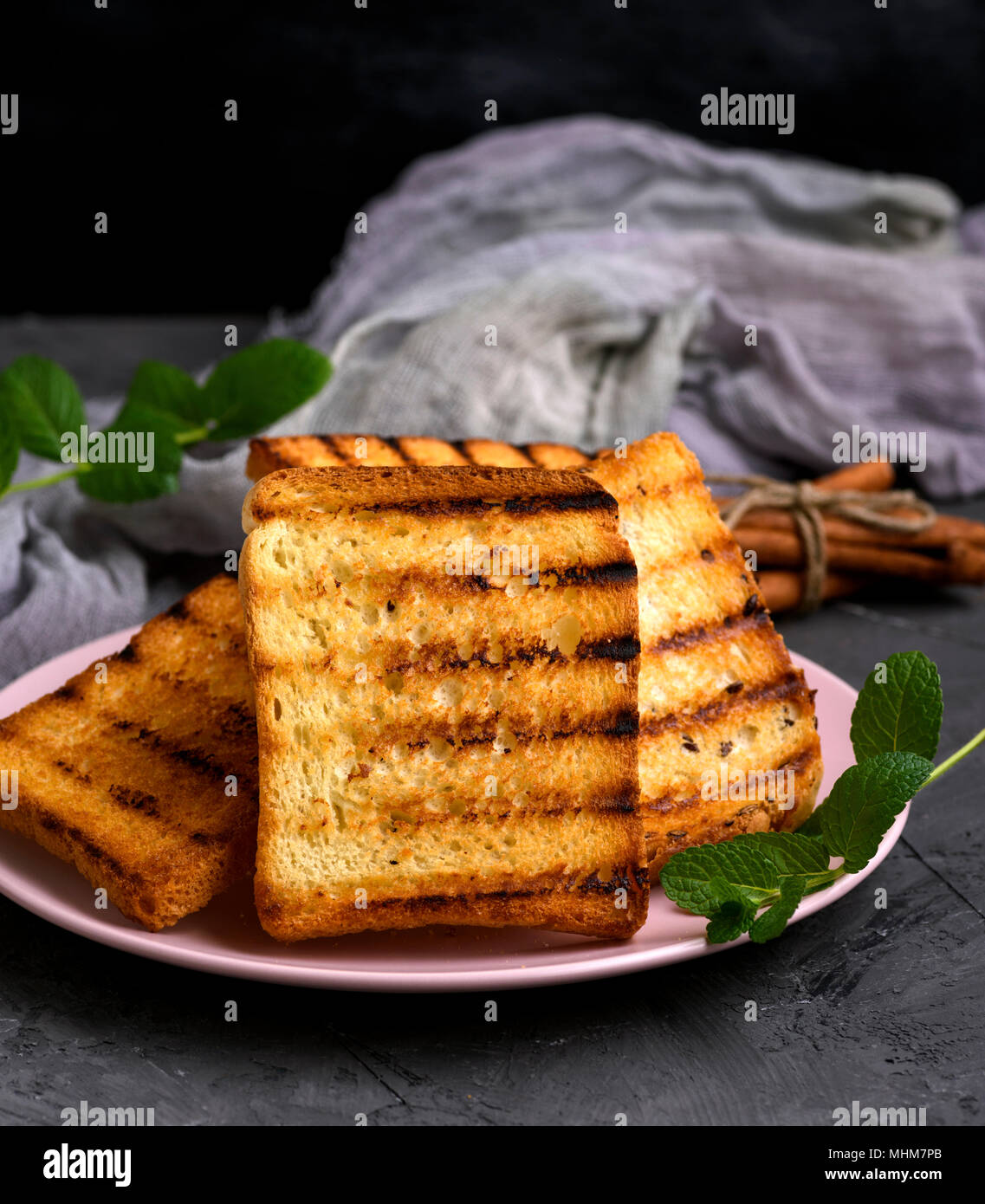 Fried square pieces of white wheat flour in a ceramic pink plate, close ...
