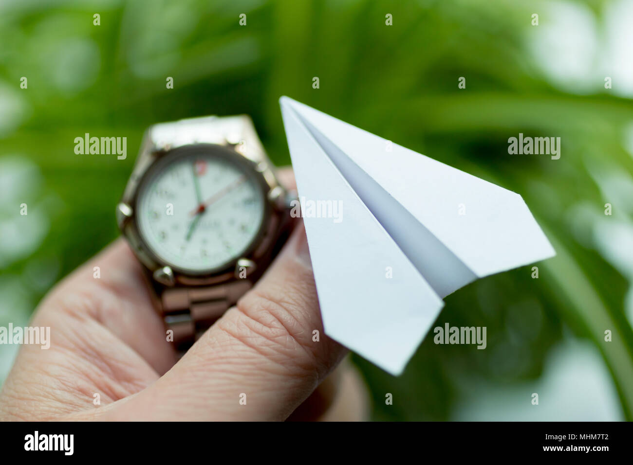 MOSCOW, RUSSIA - APRIL 22, 2018: Watch and paper airplane in hand ...