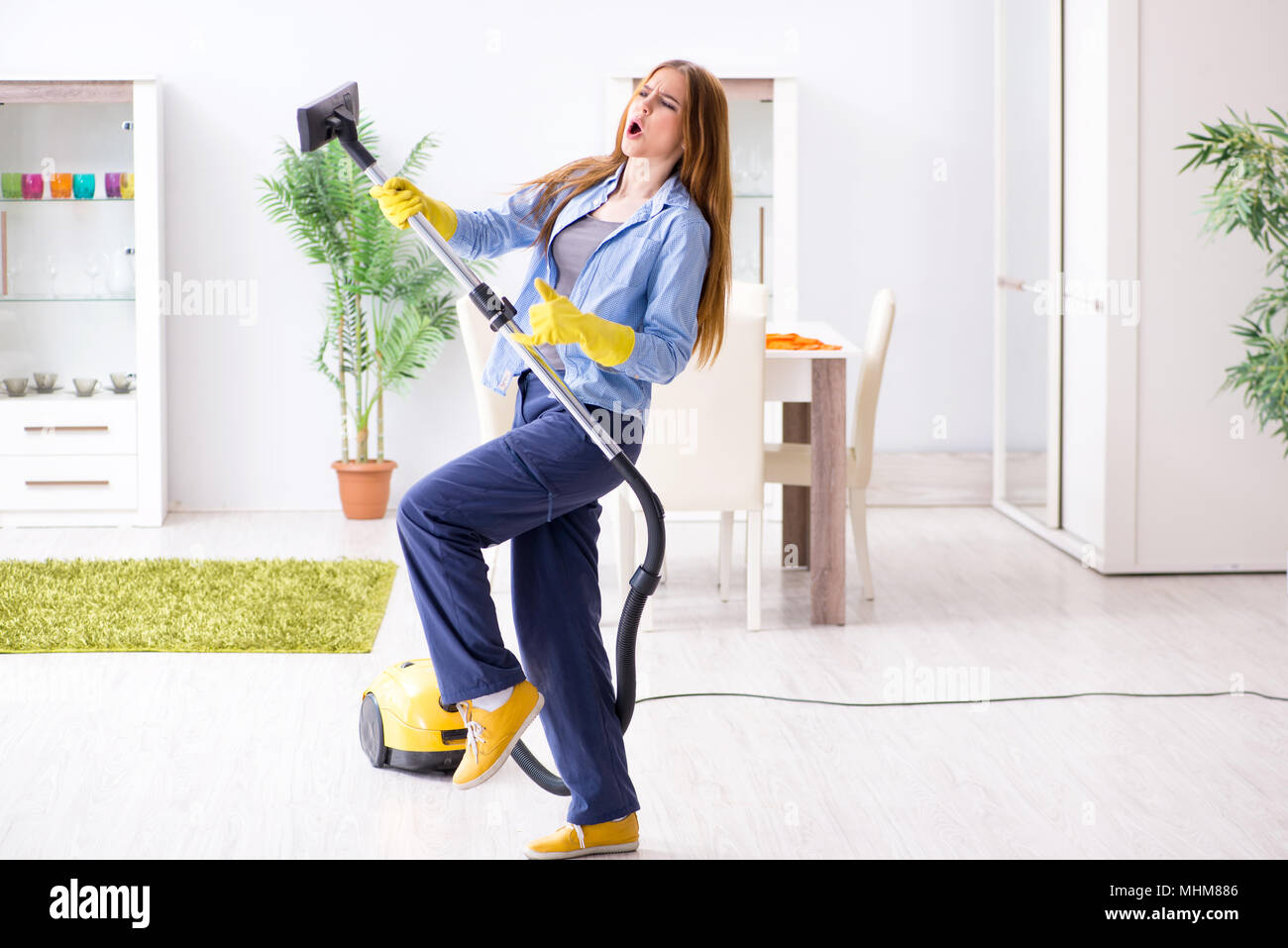 Young woman cleaning floor at home doing chores Stock Photo - Alamy