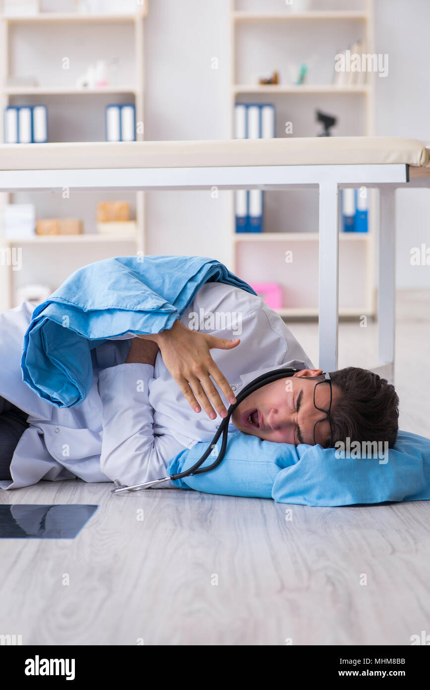 Doctor sleeping on floor after long night shift Stock Photo - Alamy