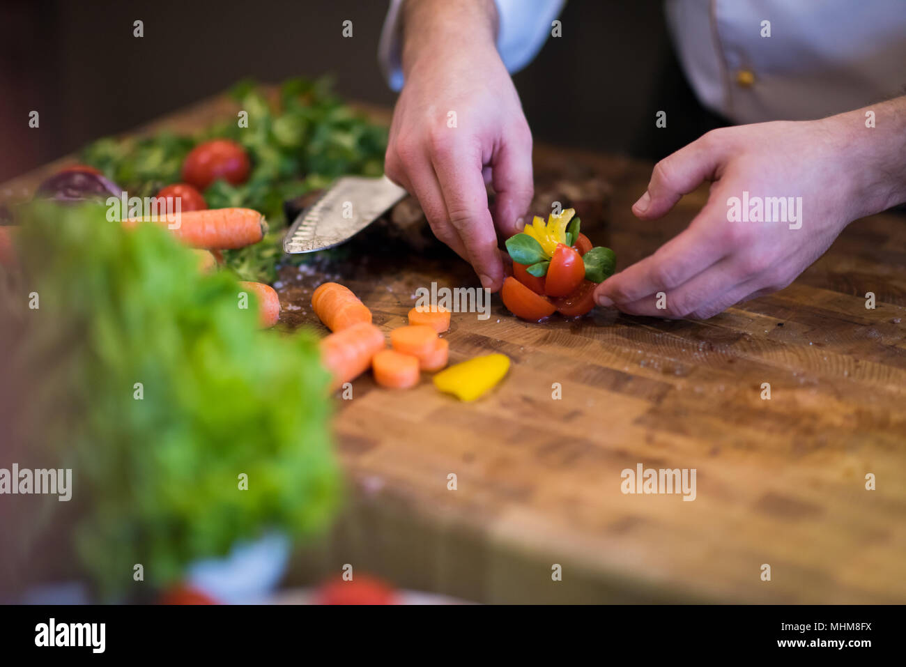 closeup of Chef hands in hotel or restaurant kitchen preparing beef ...