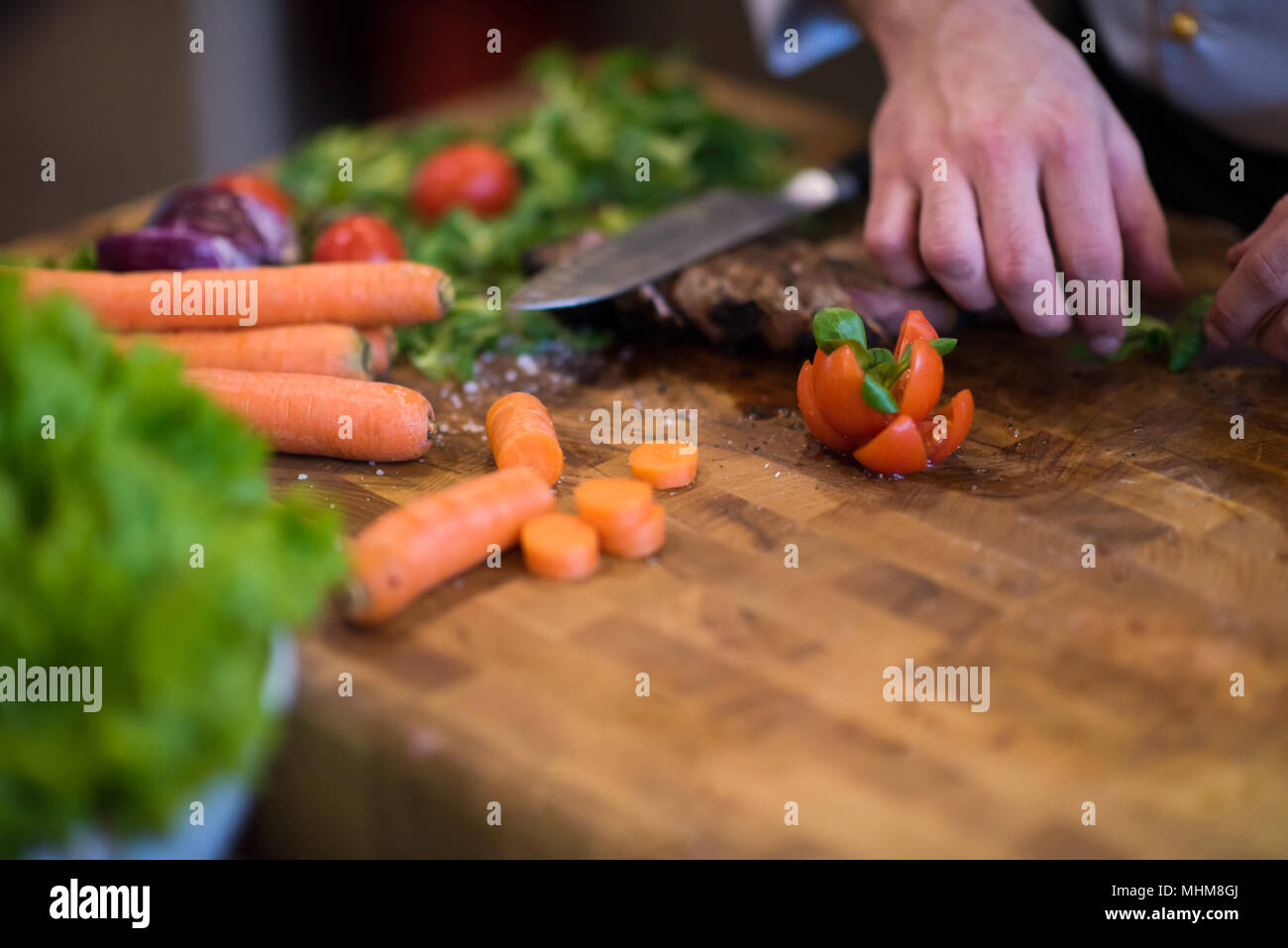 closeup of Chef hands in hotel or restaurant kitchen preparing beef ...