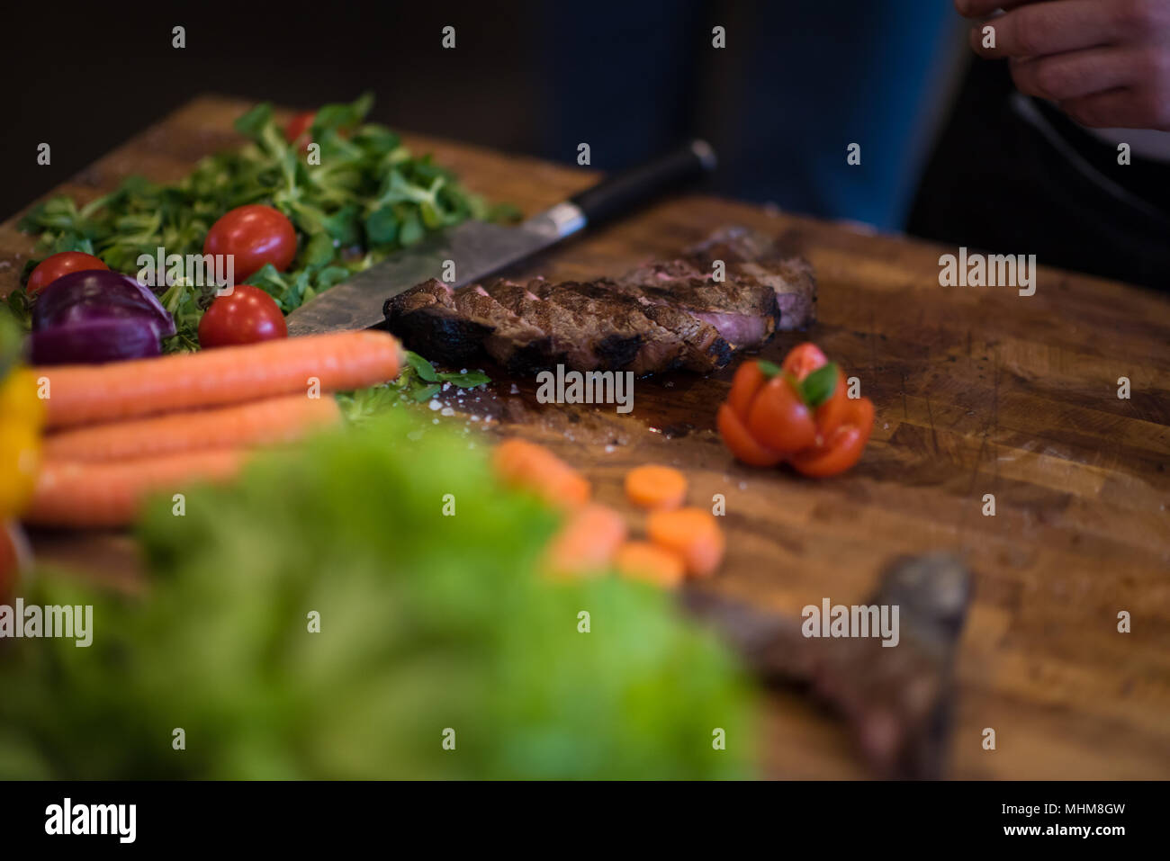 closeup of Chef hands in hotel or restaurant kitchen preparing beef ...