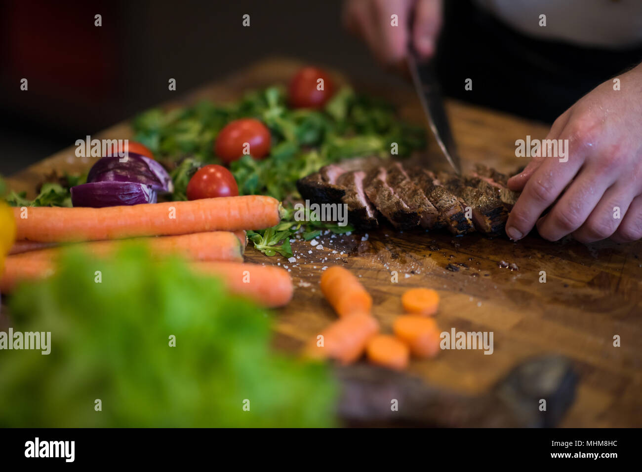 closeup of Chef hands in hotel or restaurant kitchen preparing beef ...