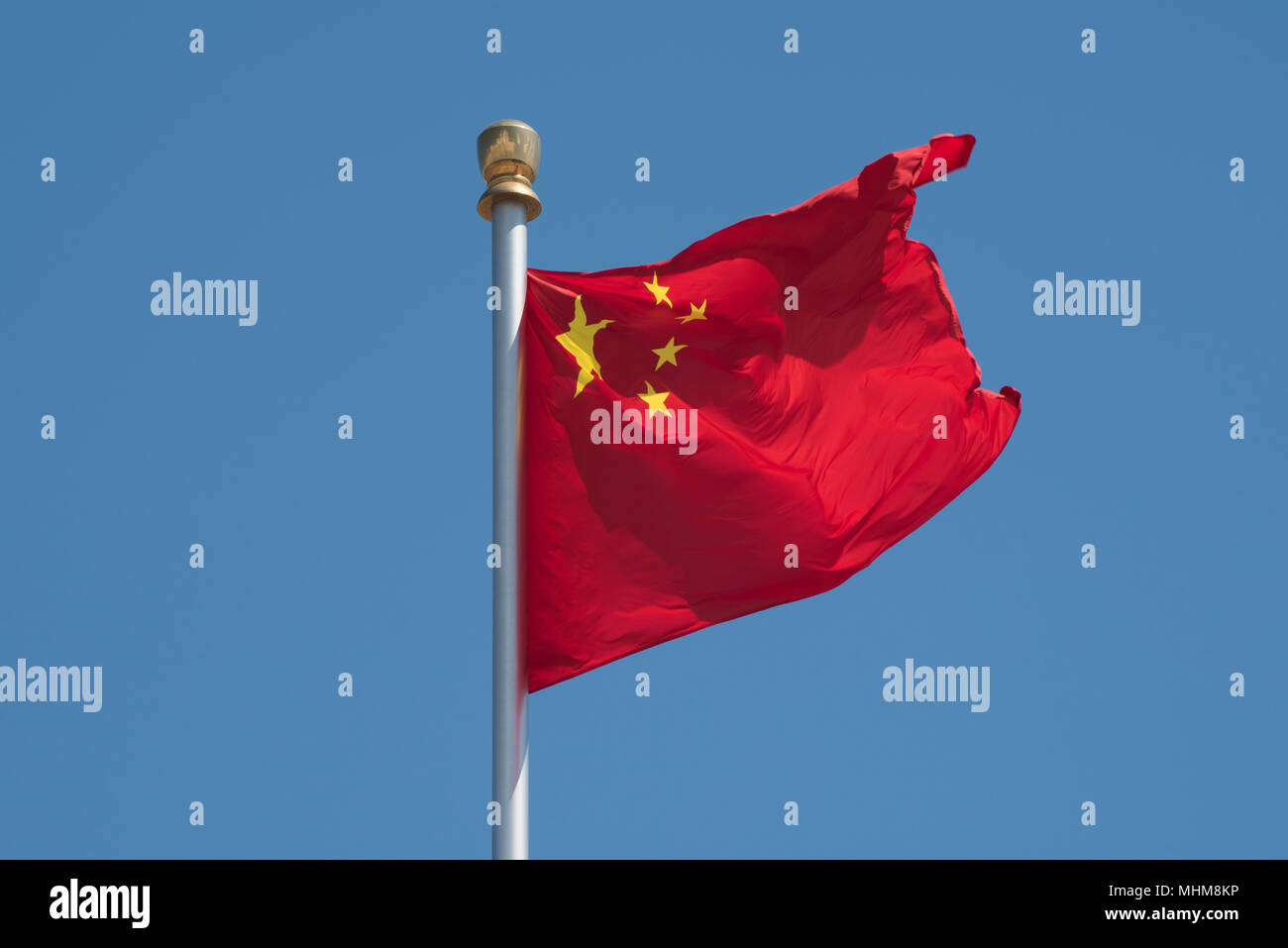 Waving Chinese national flag against blue sky Stock Photo - Alamy