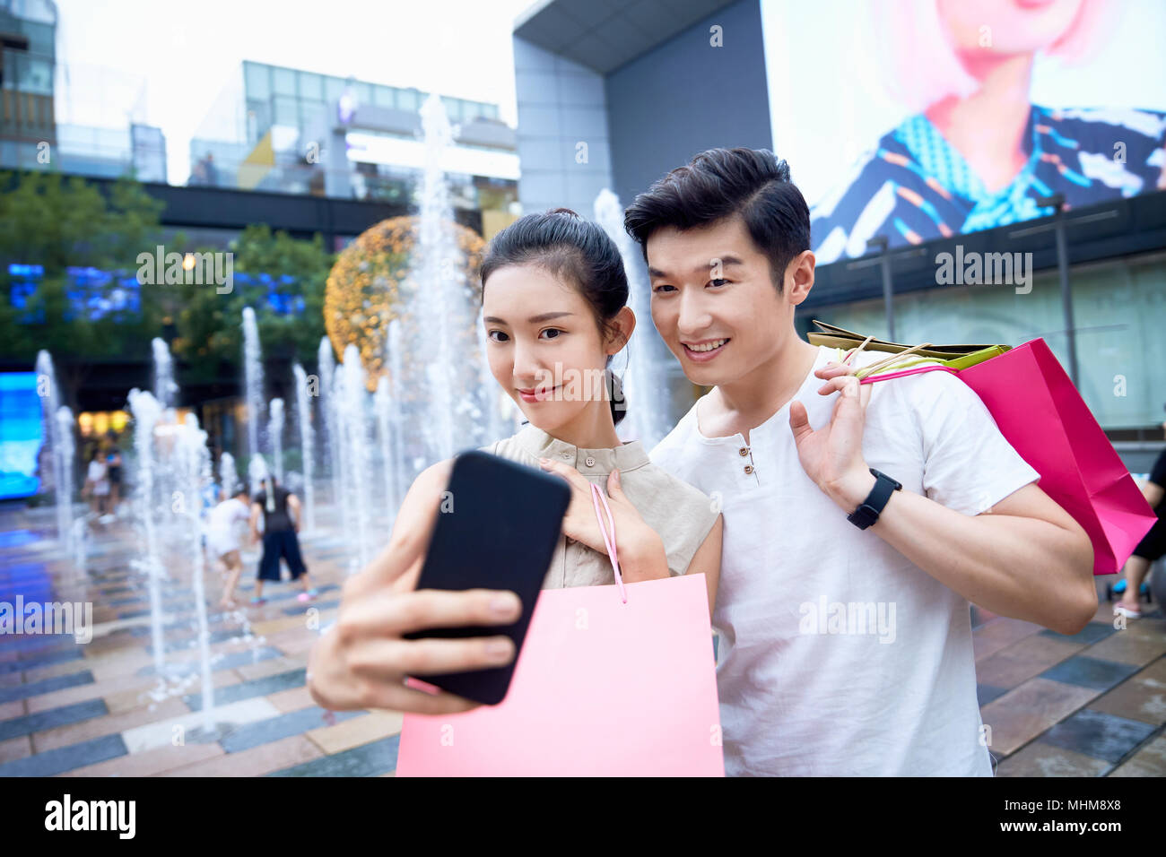 Young couples to use mobile phones Stock Photo - Alamy