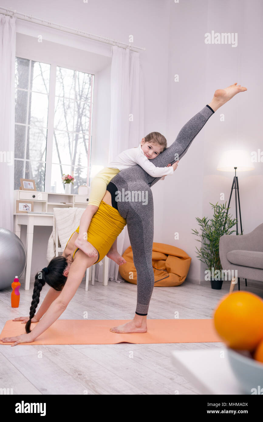 Well-built mummy doing exercises with her kid Stock Photo - Alamy